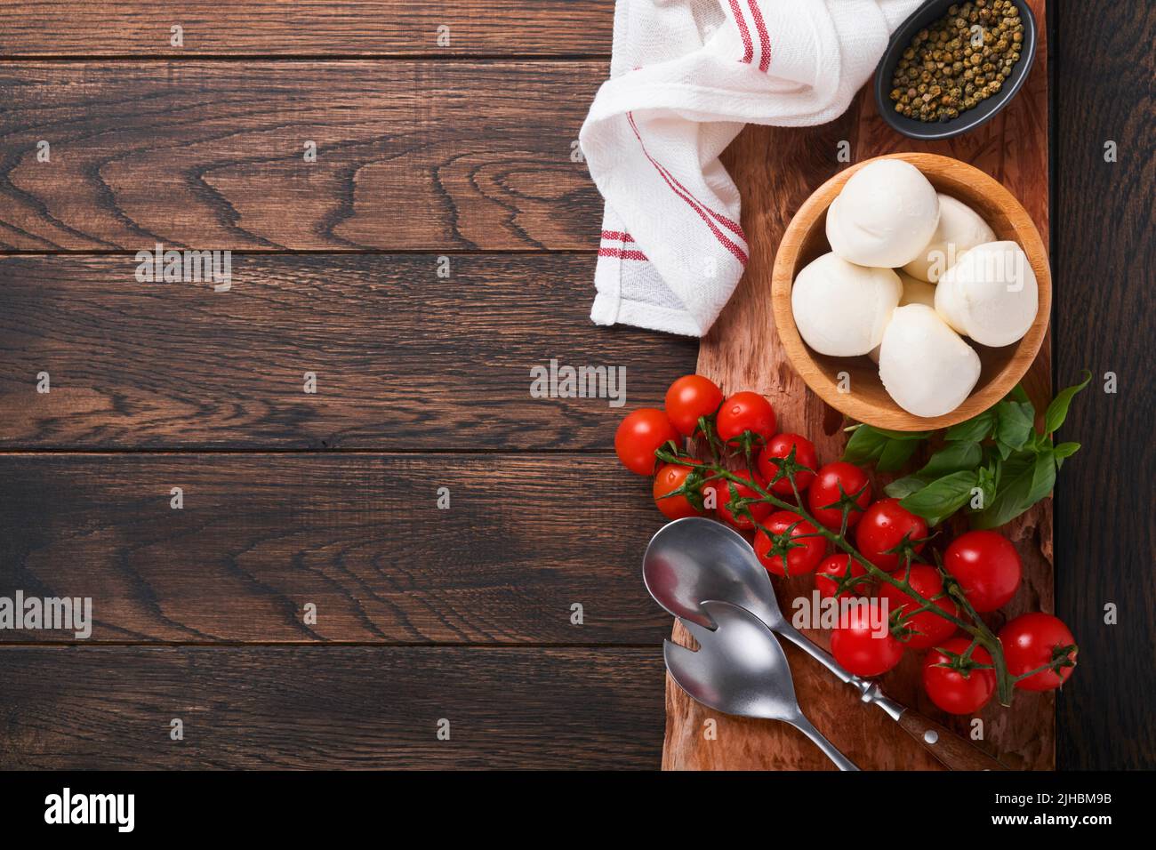 Caprese salad, ingredients for cooking. Cutting wooden board with ...