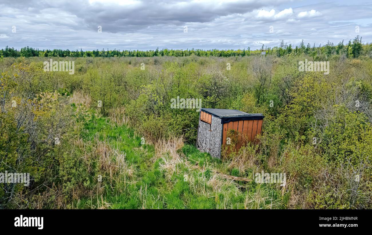 Found in a natural meadow - an abandoned hunting shack sits rotting ...