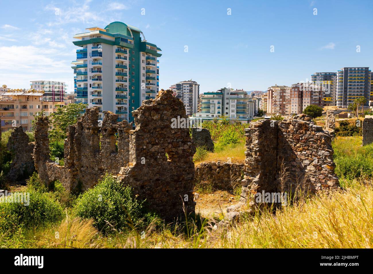 Naula Ancient City ruins among modern buildings of Mahmutlar Stock ...