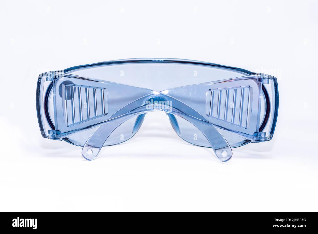 Blue plastic safety glasses on a white background isolated, close -up ...