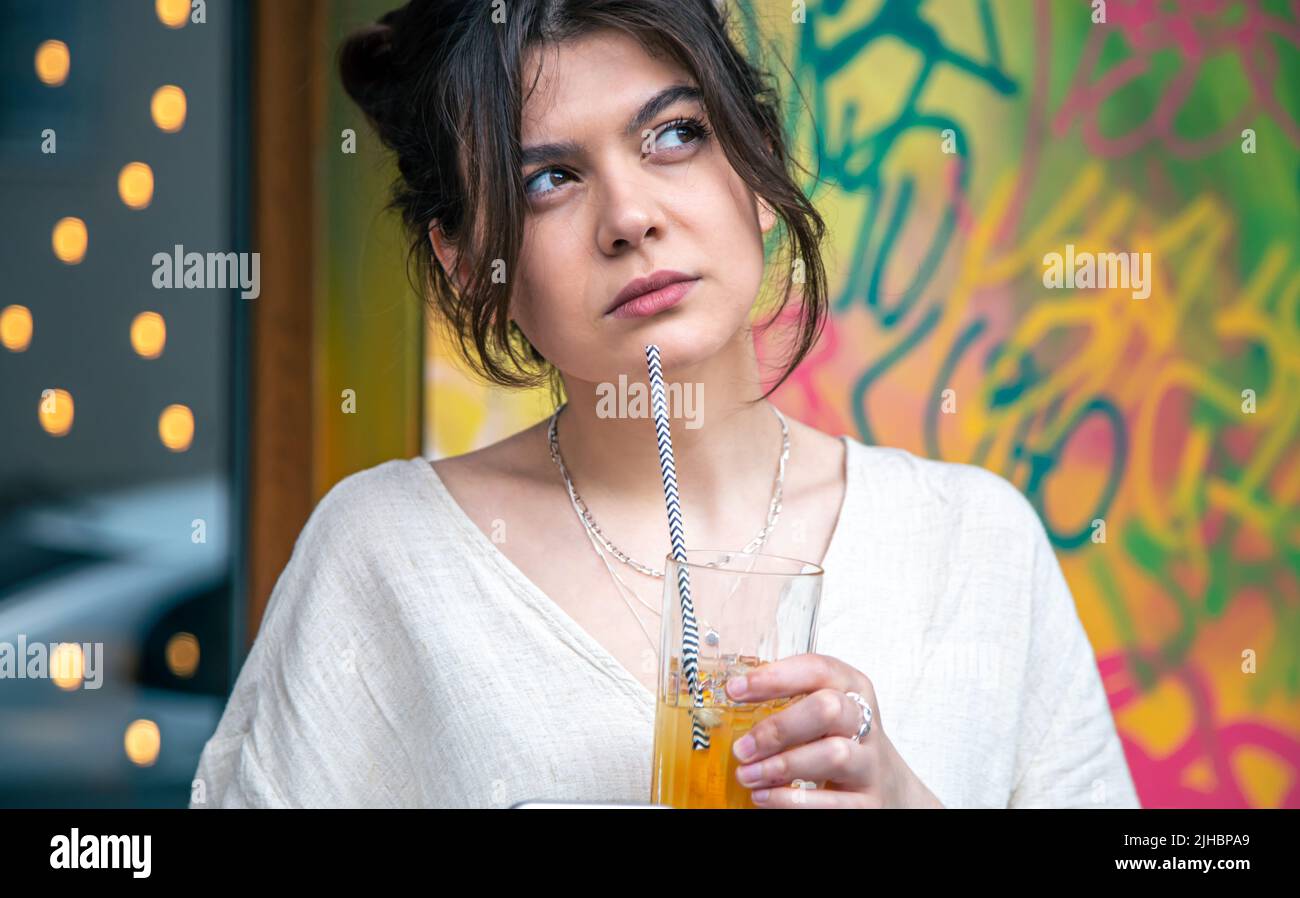 Funny young woman talking on the phone with a glass of lemonade Stock ...
