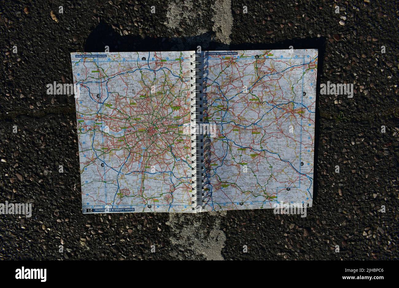 Open Road Atlas Book Placed On A Road Stock Photo - Alamy