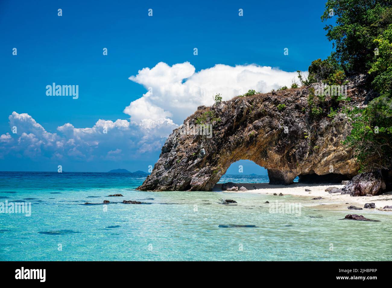 A beautiful rock formation with an arch in Khai island at Tarutao ...