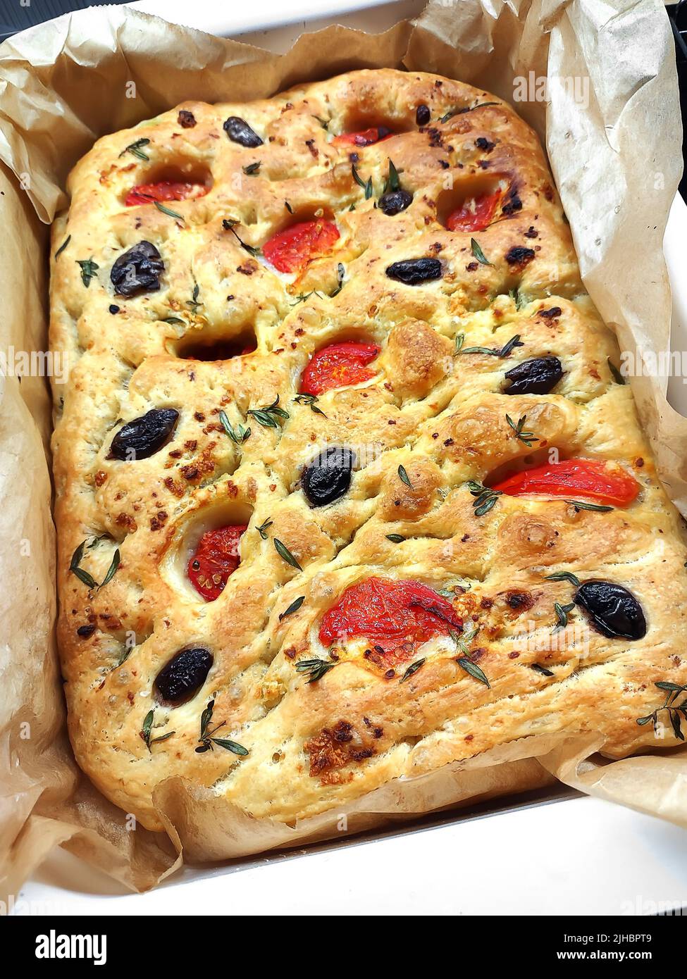 Homemade Focaccia with tomatoes and olives in a tray Stock Photo - Alamy
