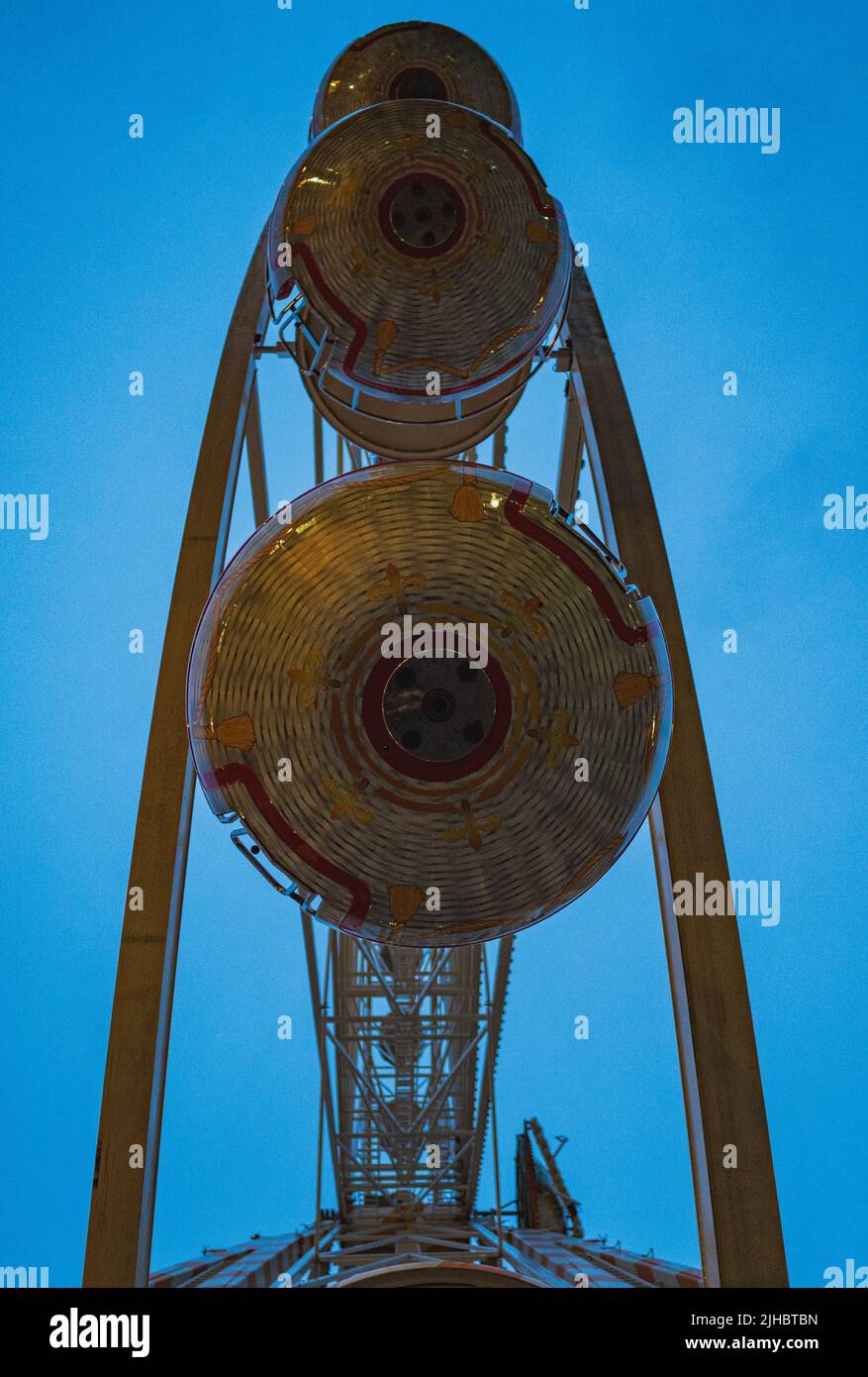 Recreation in amusement park.View of Ferris wheel cab from below on ...