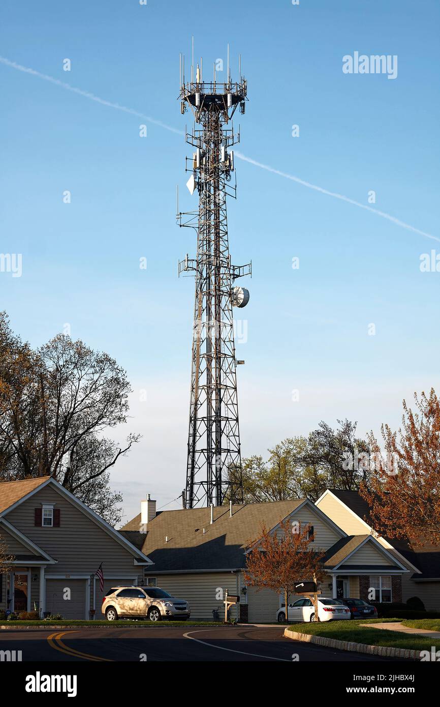 cellular communications tower, tall, behind houses, technology ...