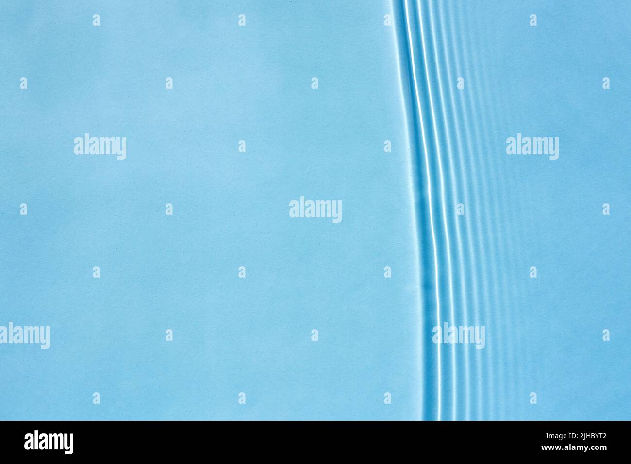 Straight vertical wave, ripples on the surface of transparent blue and ...