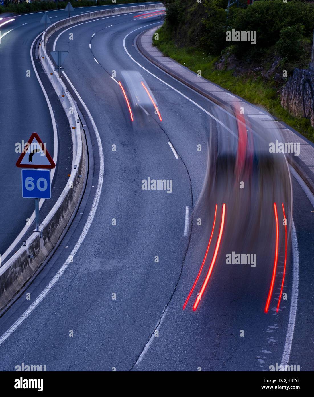Car lights at night on road curves Stock Photo - Alamy