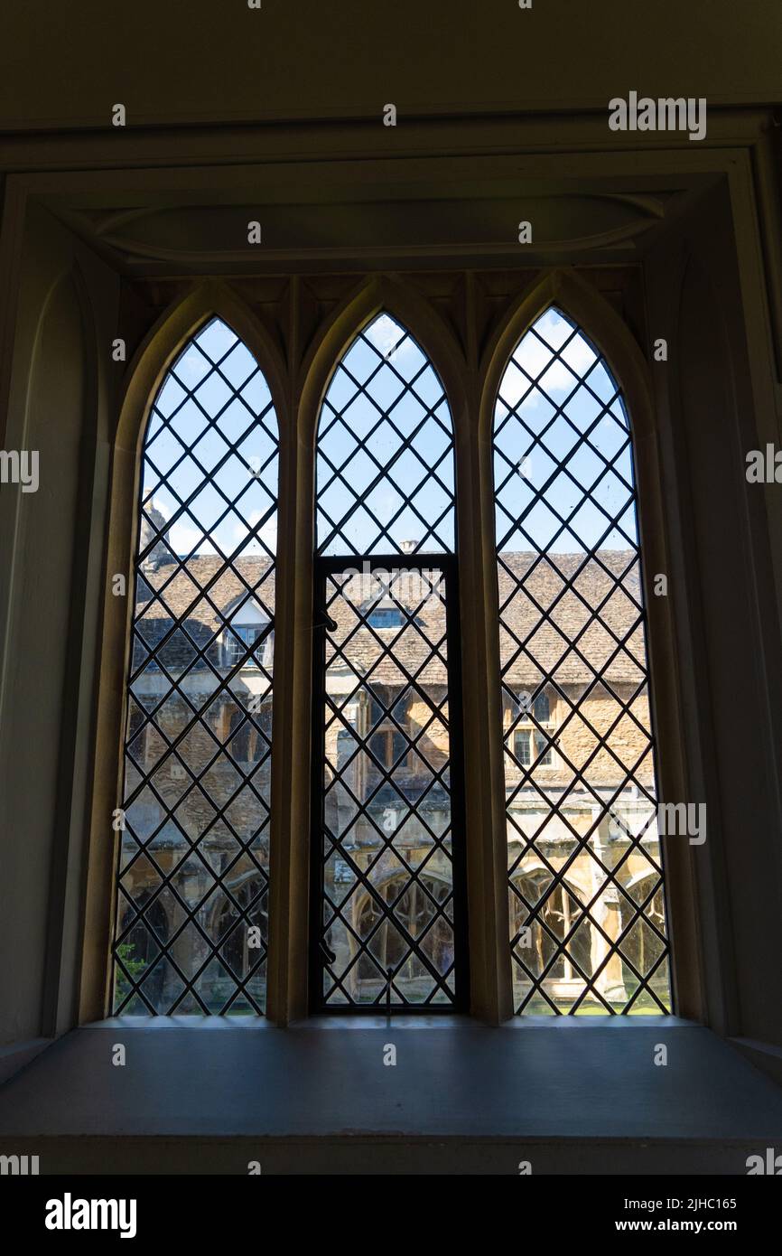 An indoor vertical view through an abbey window, vintage Gothic style ...