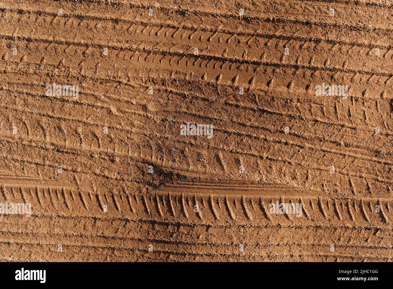 Car wheel tracks on dry sandy ground Stock Photo - Alamy