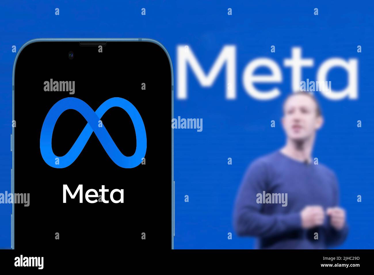 Smartphone with Meta or MetaVerse logo lies on wooden table with two ...