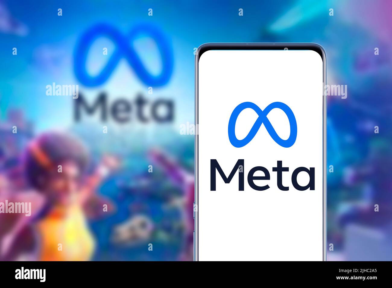 Smartphone with Meta or MetaVerse logo lies on wooden table with two ...