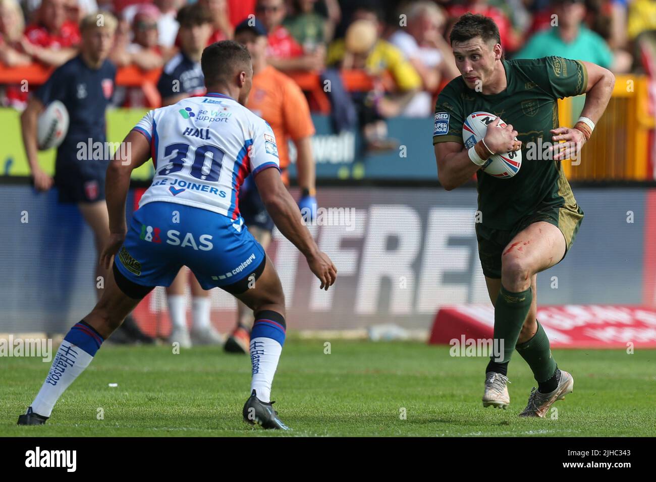 Sam Wood #24 of Hull KR runs at Corey Hall #30 of Wakefield Trinity ...