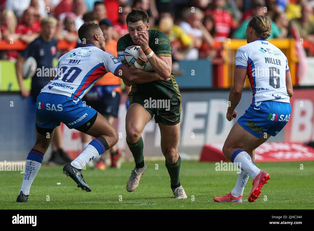 Sam Wood #24 of Hull KR runs at Corey Hall #30 of Wakefield Trinity ...