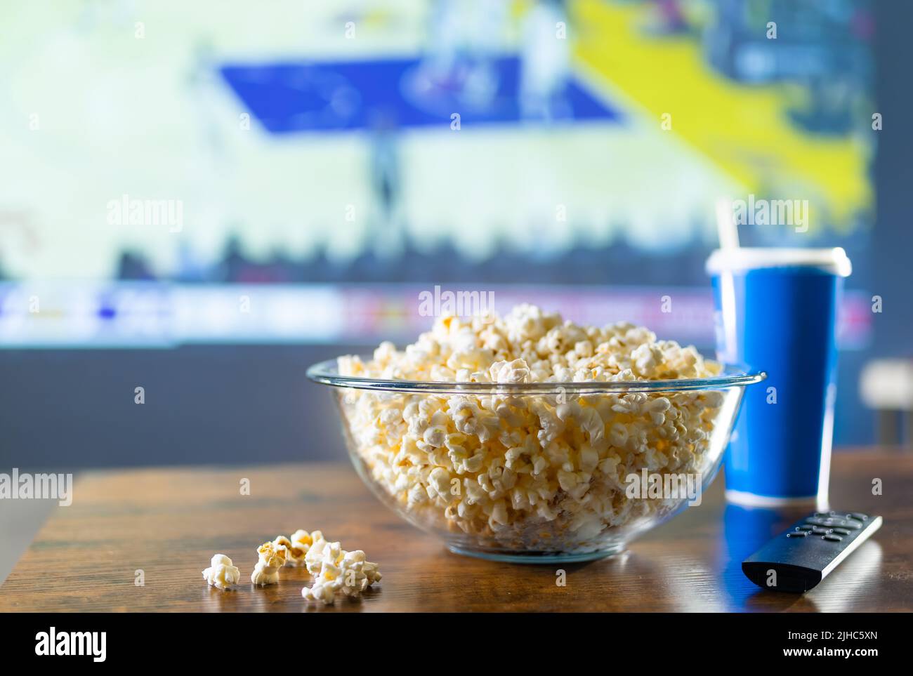 Fast food - popcorn in a glass bowl, carbonated drink in a plastic ...