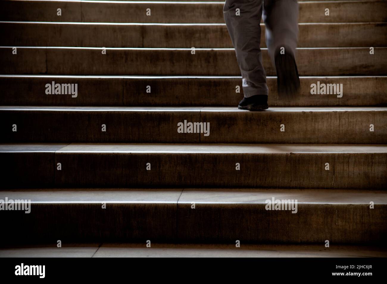 A man is walking up the steps of an underground passage Stock Photo - Alamy