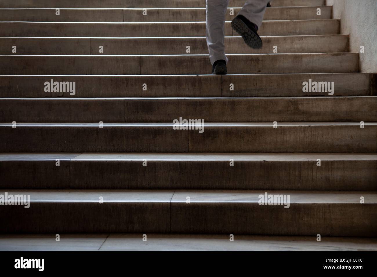 A man is walking up the steps of an underground passage Stock Photo - Alamy