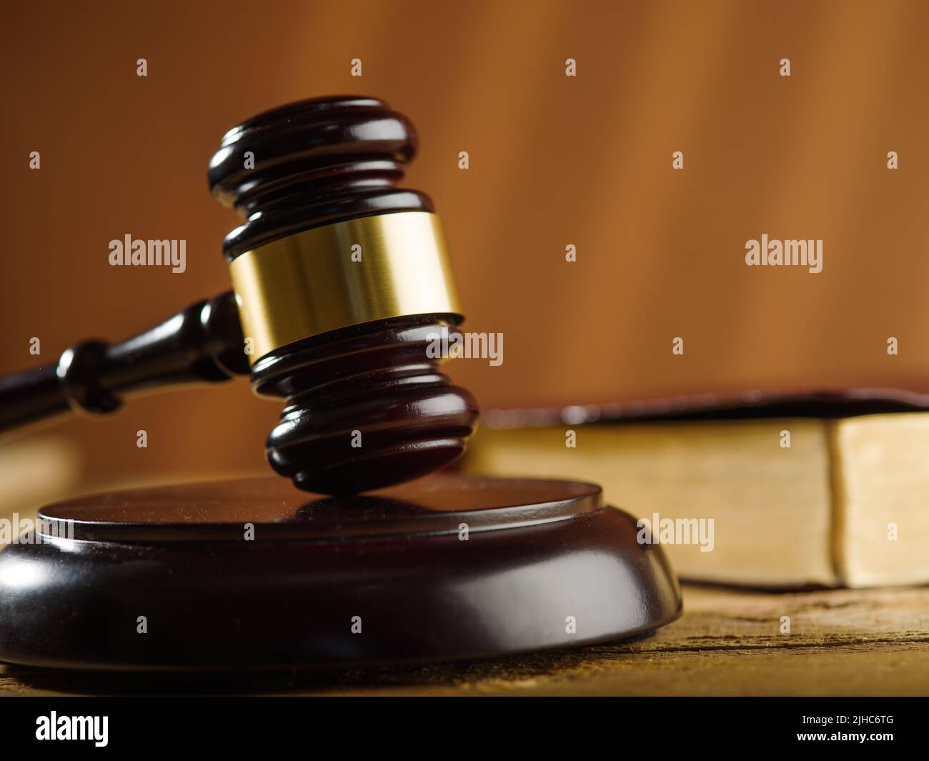 Close-up. Judge's wooden gavel and an open book in the background ...