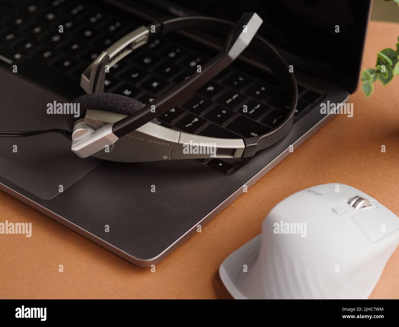 Close-up. Headphones on a laptop, computer mouse on a beige background ...
