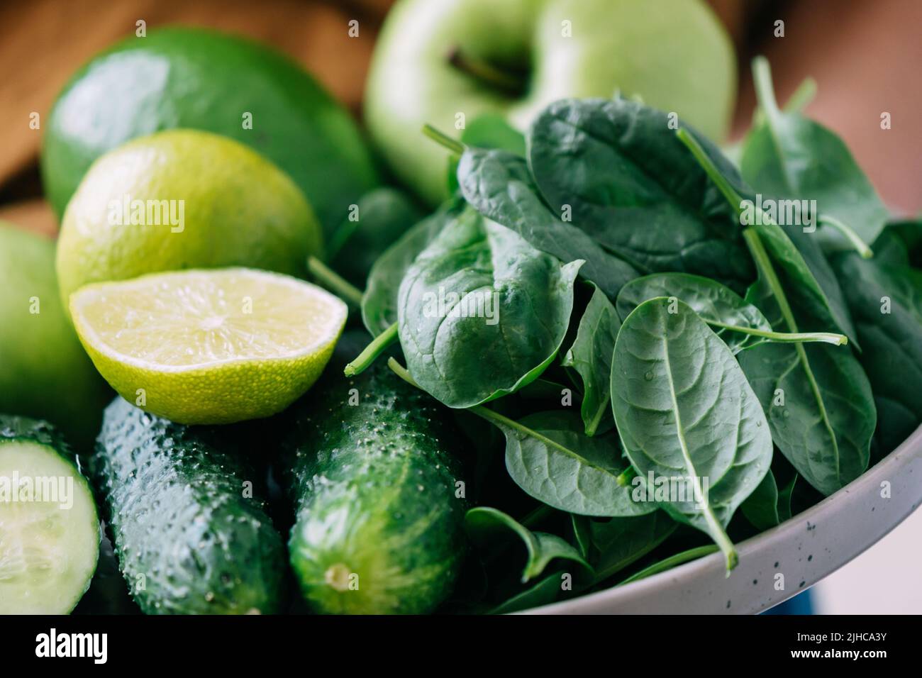 Green vegetables and fruits close-up, soft focus. Vegetarianism healthy ...