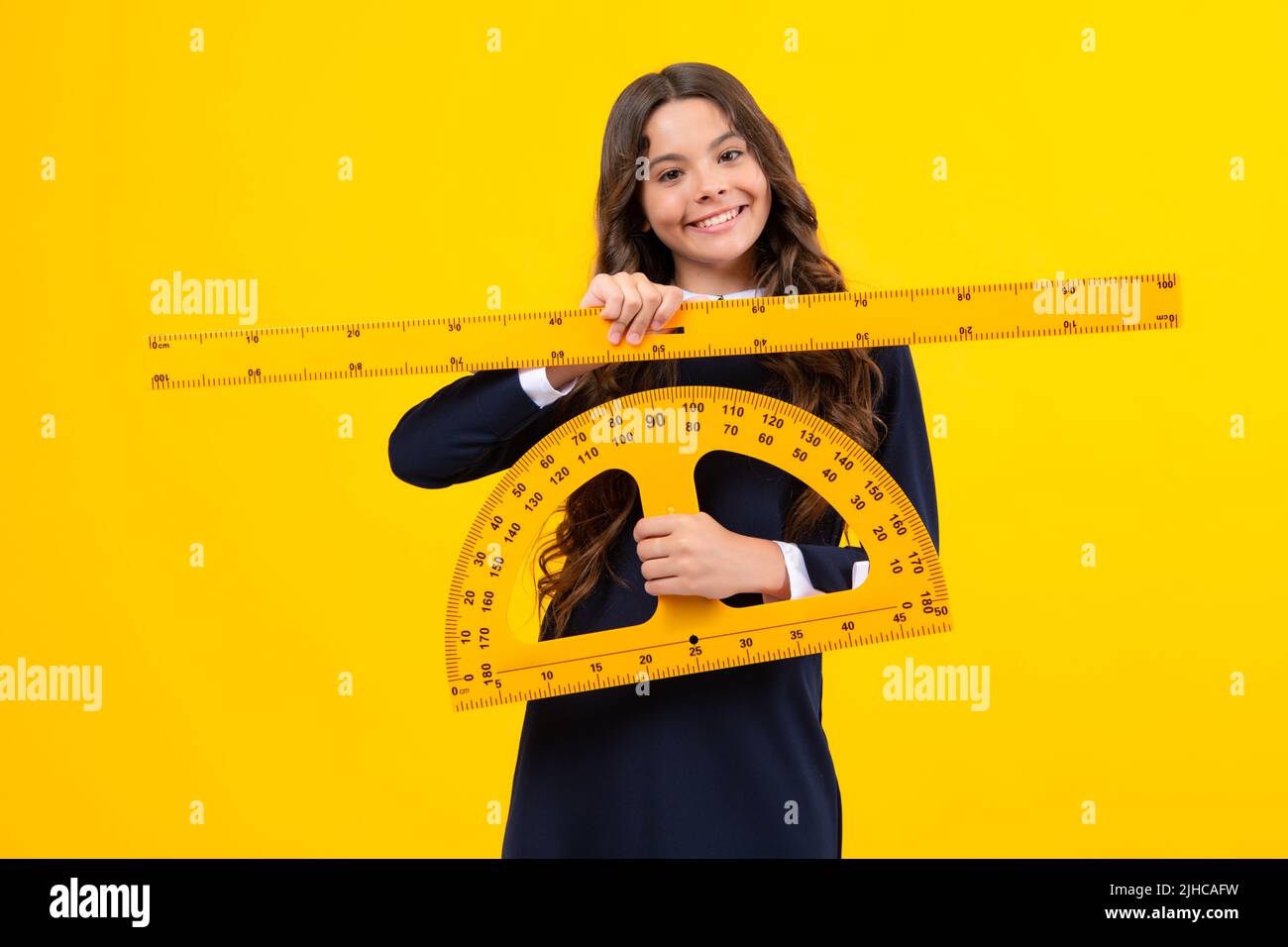 Measuring school equipment. Schoolgirl holding measure for geometry ...