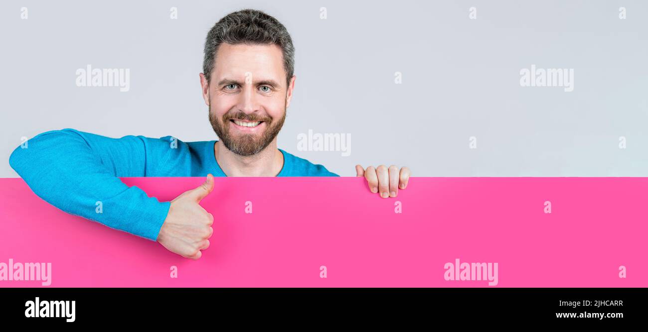 Man face portrait, banner with copy space. happy man behind blank paper ...