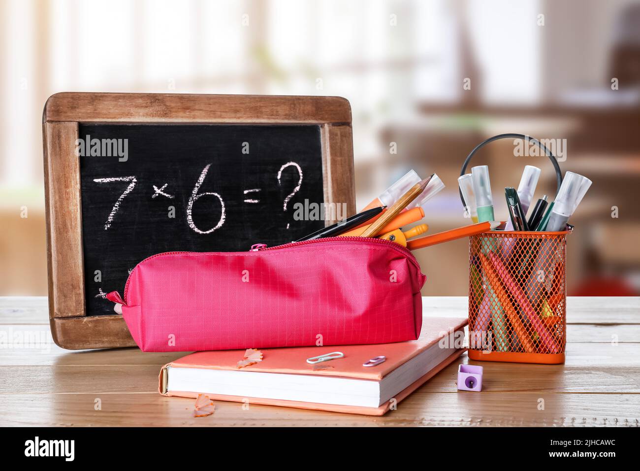Set of school stationery on table in classroom Stock Photo - Alamy