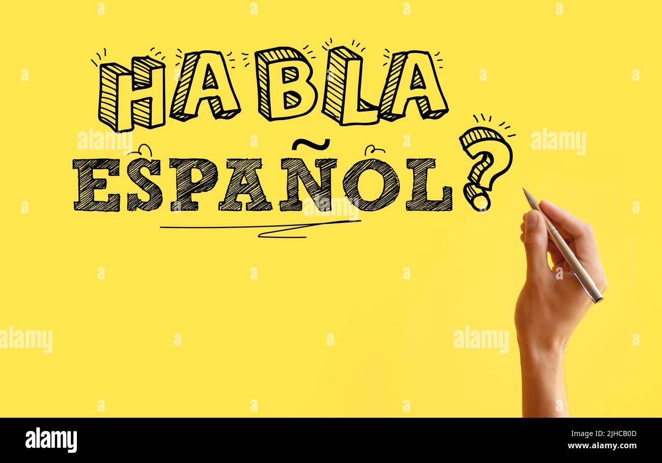 Hand writing text HABLA ESPANOL? (DO YOU SPEAK SPANISH?) on yellow ...