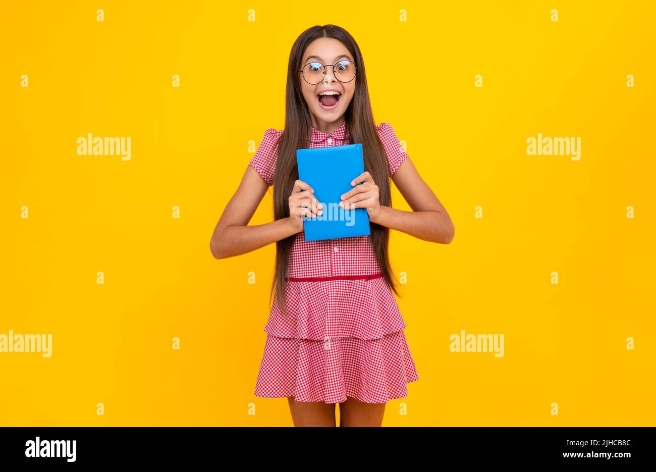 Amazed teen girl. Schoolgirl with copy book posing on isolated ...