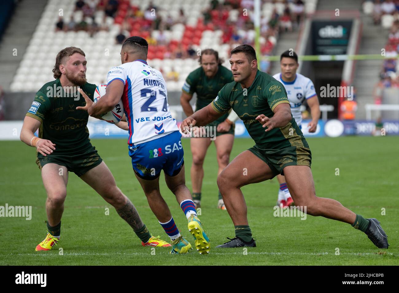 Lewis Murphy #27 of Wakefield Trinity is tackled by Ethan Ryan #23 of ...
