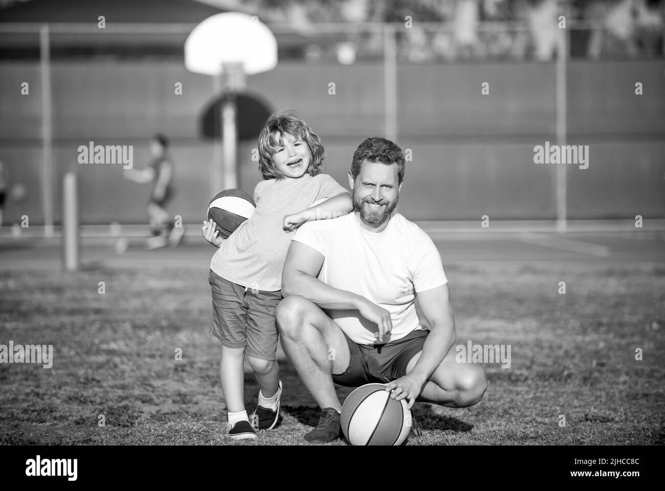 dad and kid boy hold sport ball. child play basketball. childhood and ...