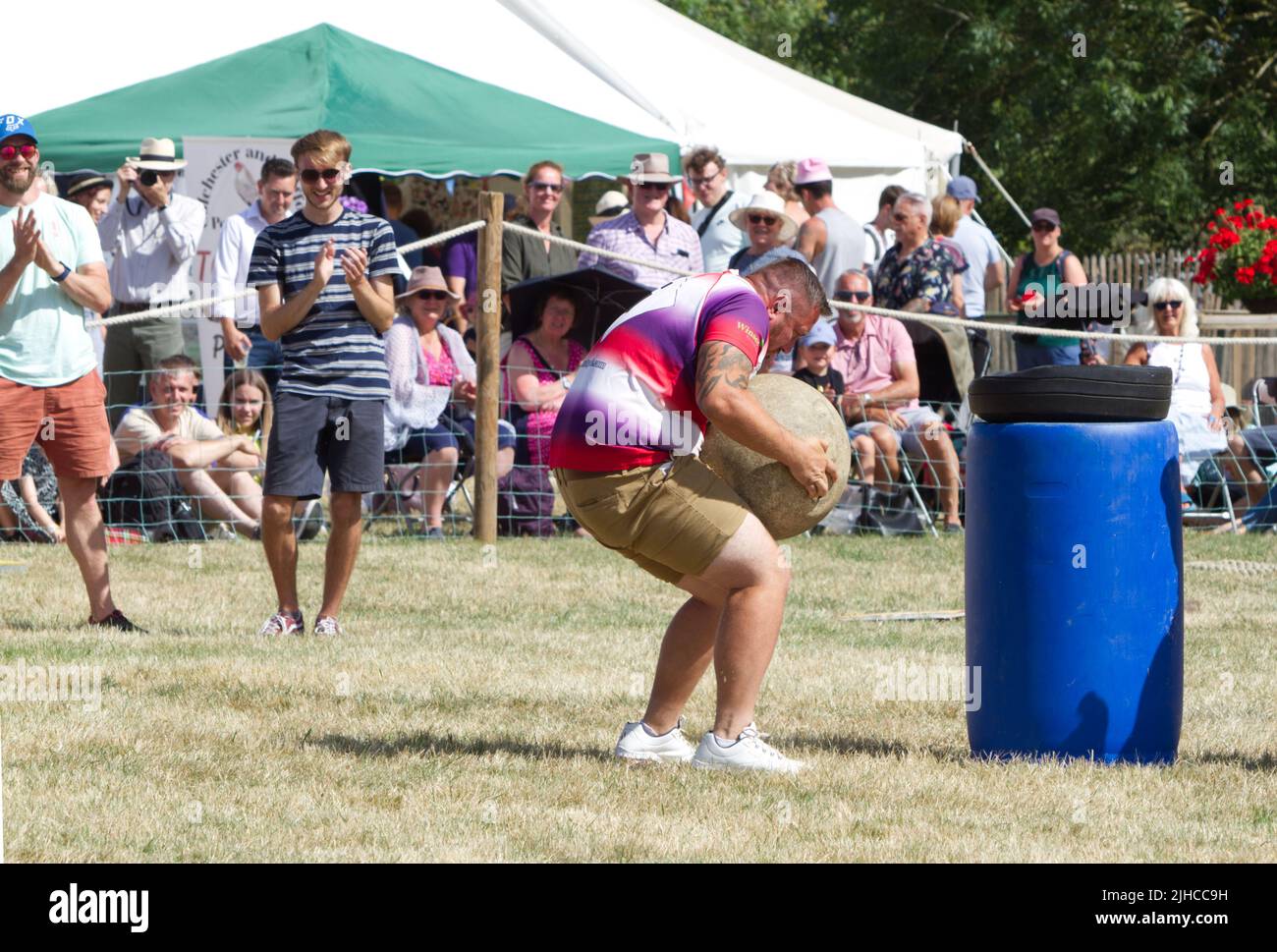 A participant succeeds in lifting a heavy weight as part of the ...