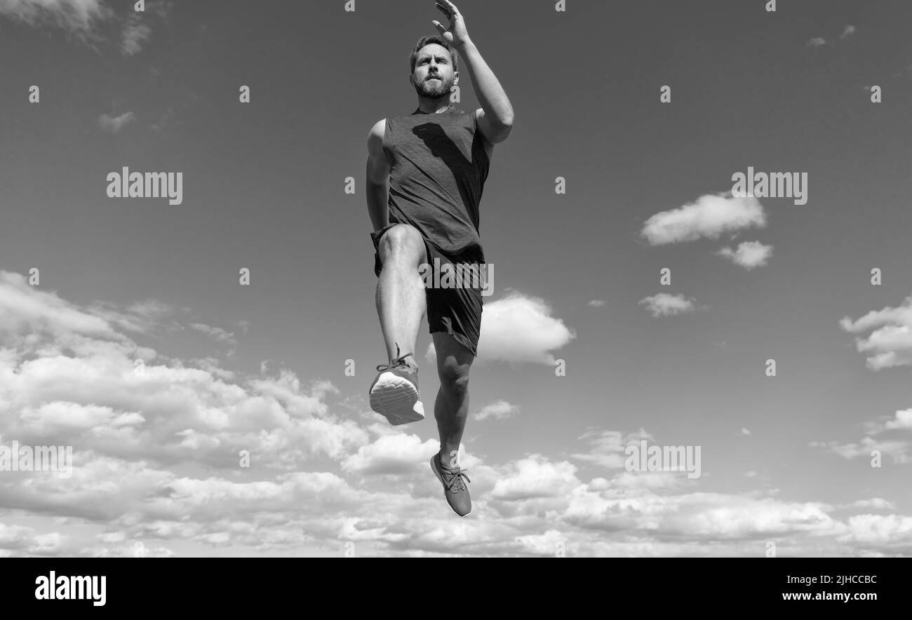 muscular man sprinter running in sportswear outdoor on sky background ...