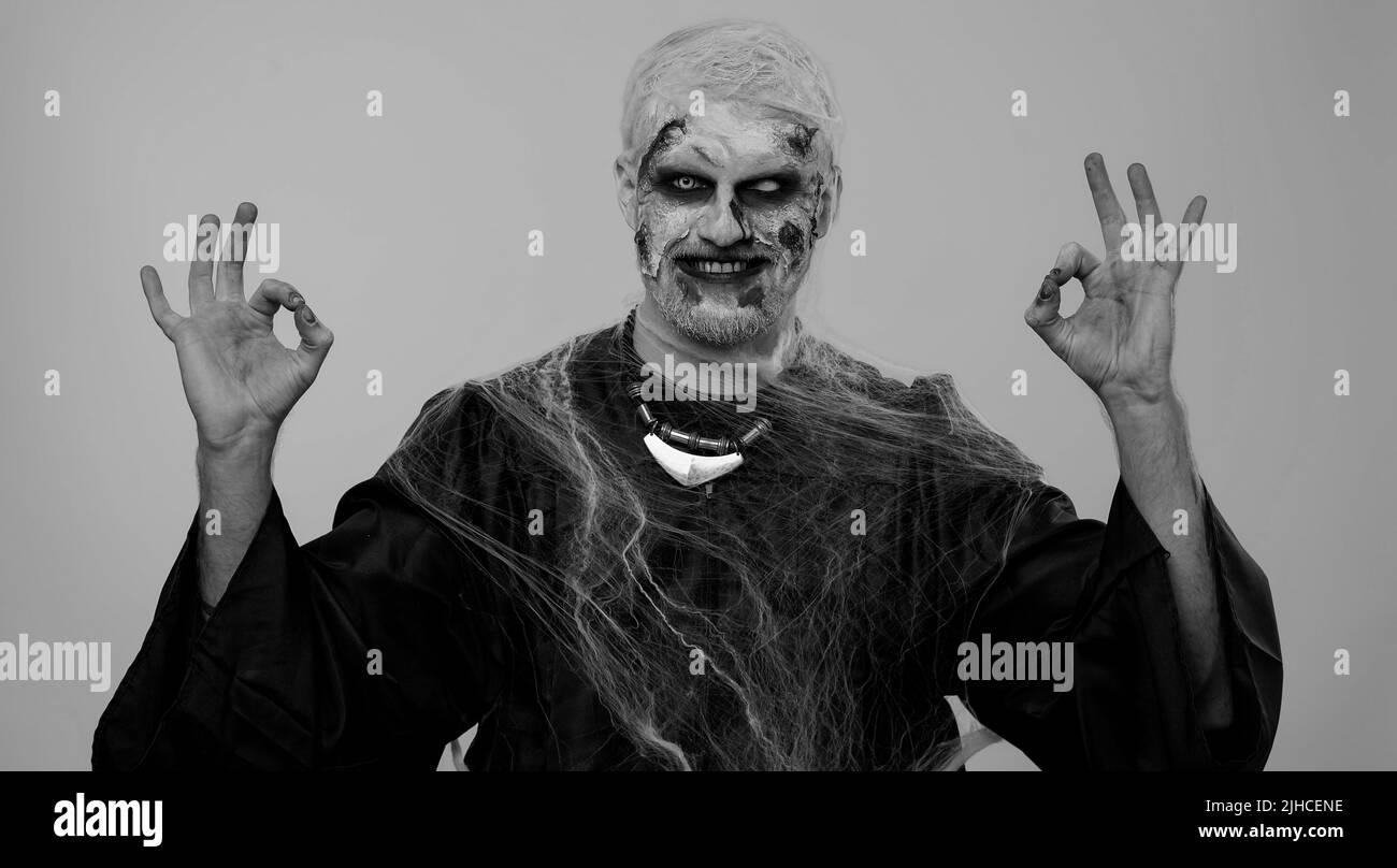 Creepy man with bloody scars face, Halloween stylish zombie make-up ...