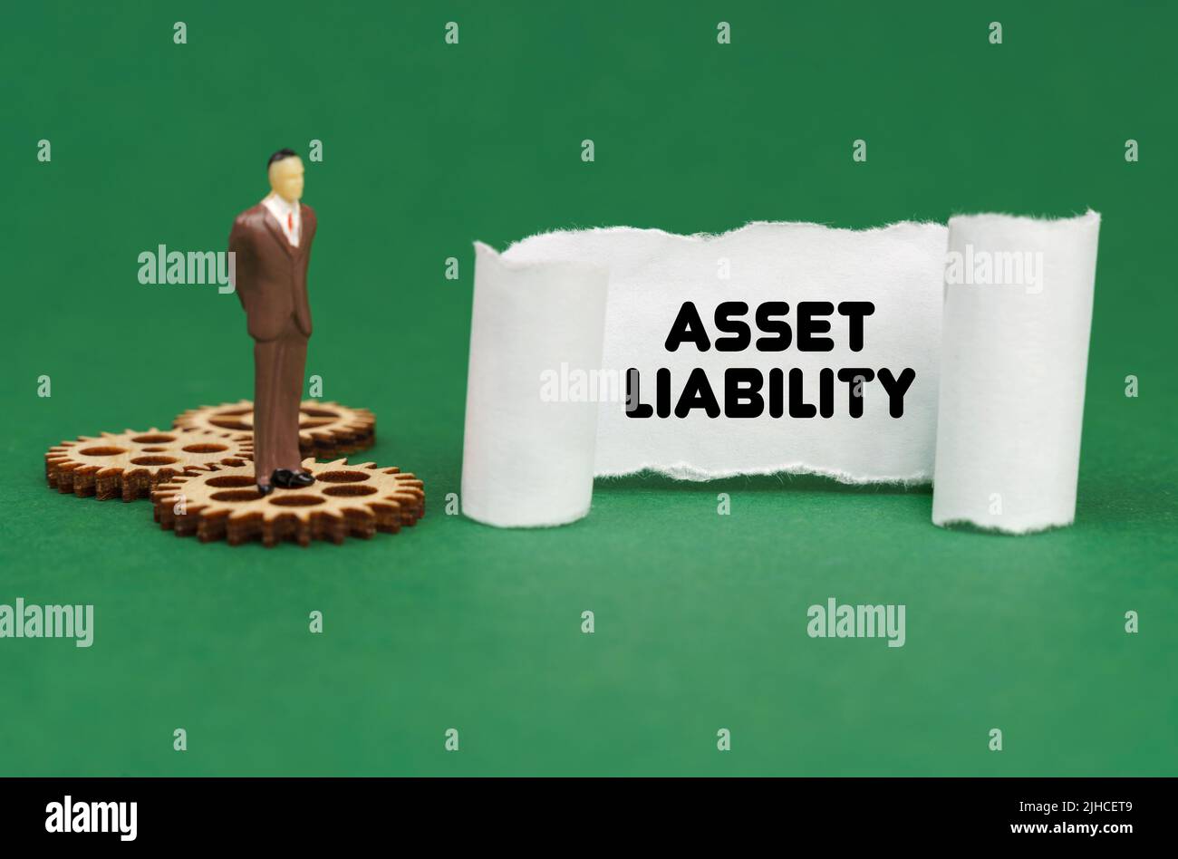 Business concept. The figure of a man stands on the gears and reads the ...