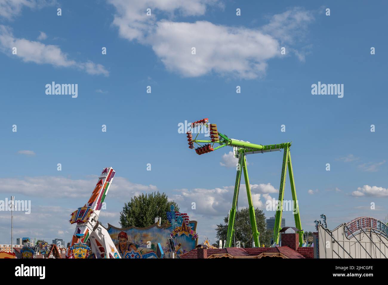 Outdoor sunny view of pendulum amusement ride, rotate and swing down ...