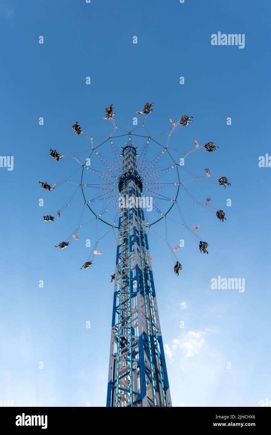 Low angle view of Star flyer, Chain carousel amusement ride, move up ...