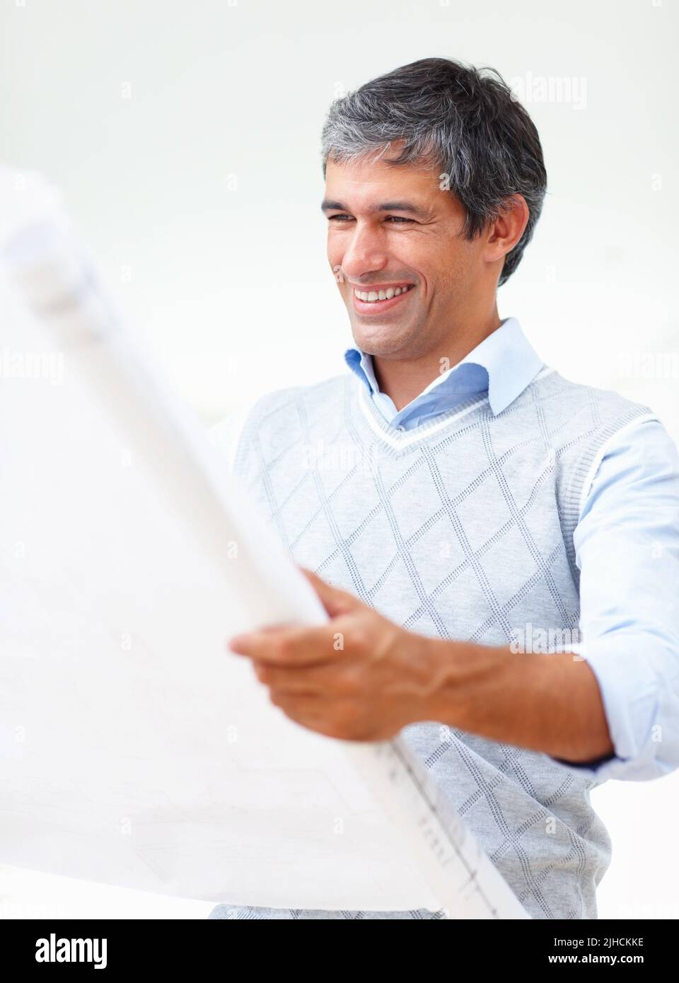 Male architect going through blueprint. Portrait of successful business ...