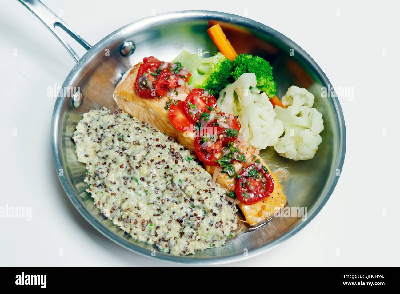 pan seared salmon fish with creamy quinoa, fresh tomato and steam ...