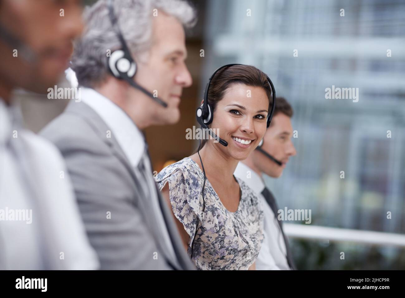 Waiting to take your call. Portrait of an attractive customer service ...