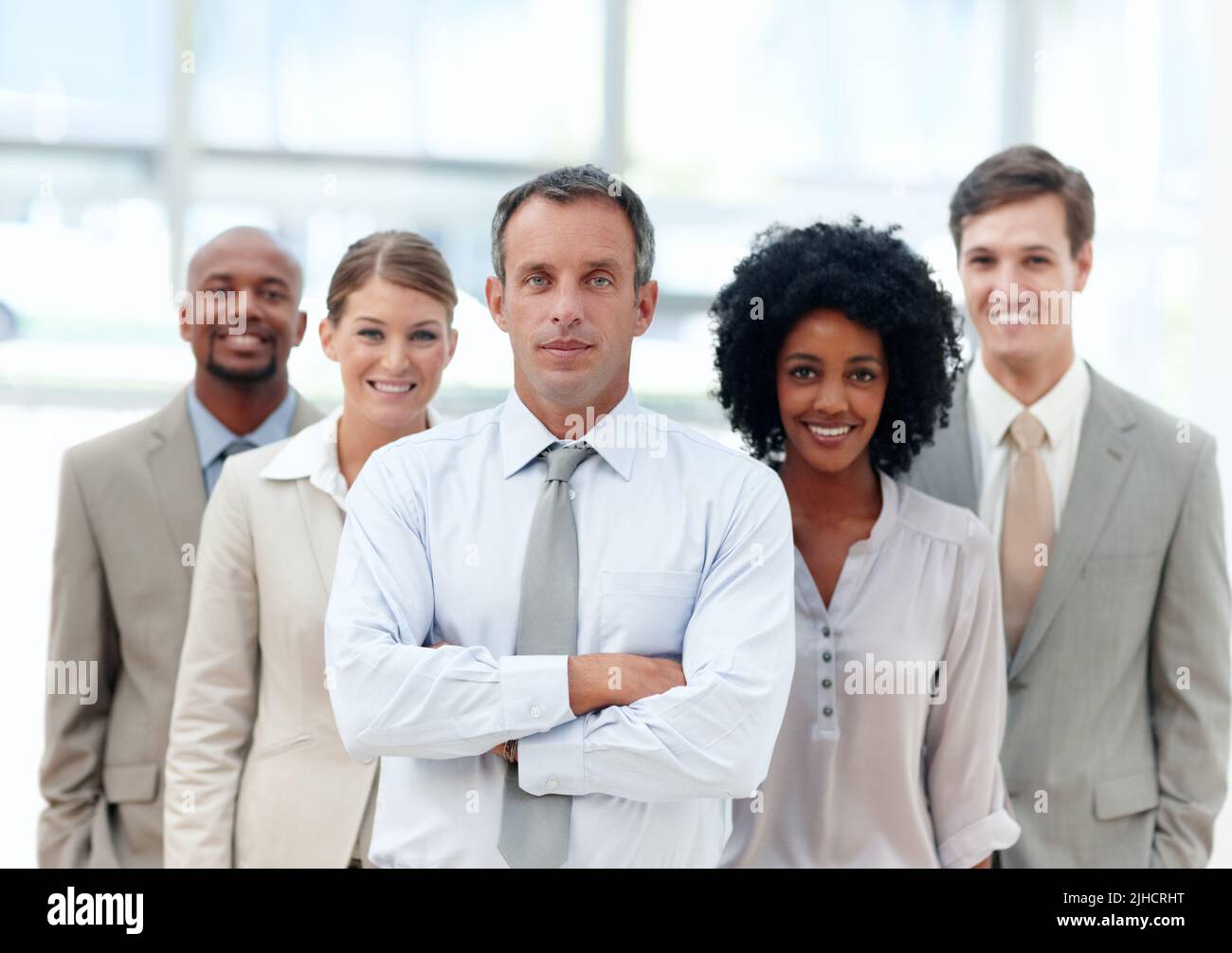 Leading them to success. Business manager stands confidently with his ...