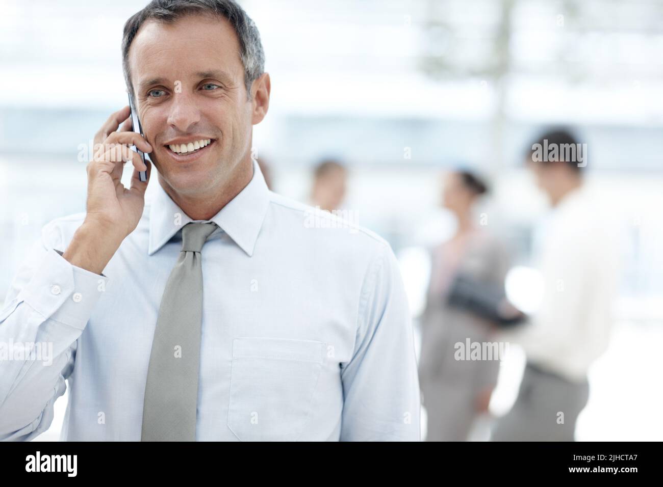 Smiling all the way to success. a businessman standing in an office ...