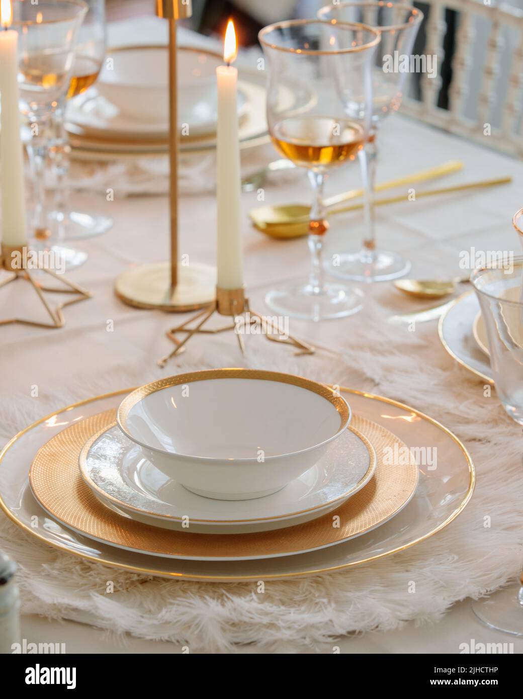 The beautiful ceremonial golden tableware with a candlelight decoration ...
