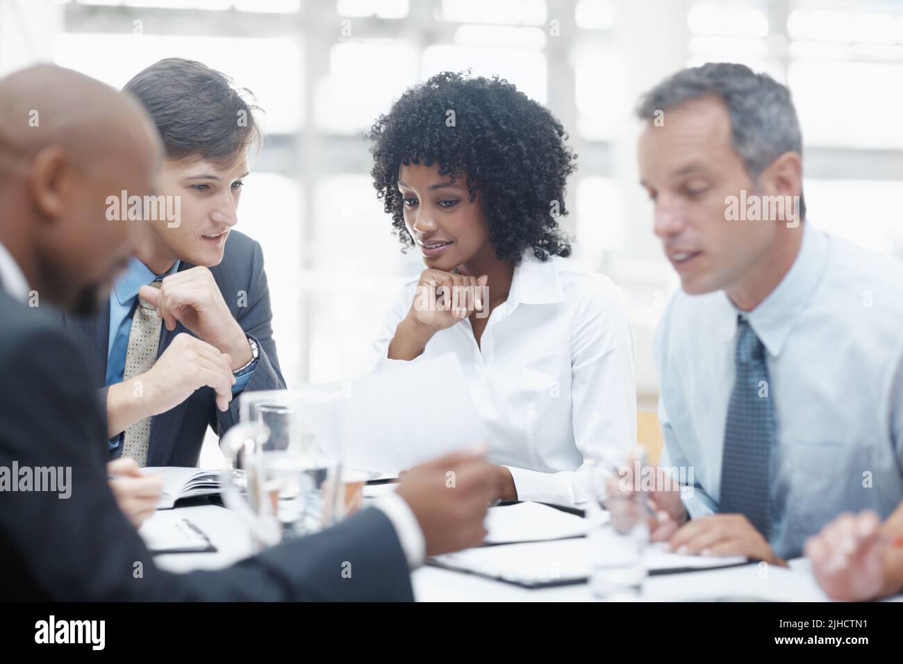 Detailed deliberations. A diverse group of business people going over ...