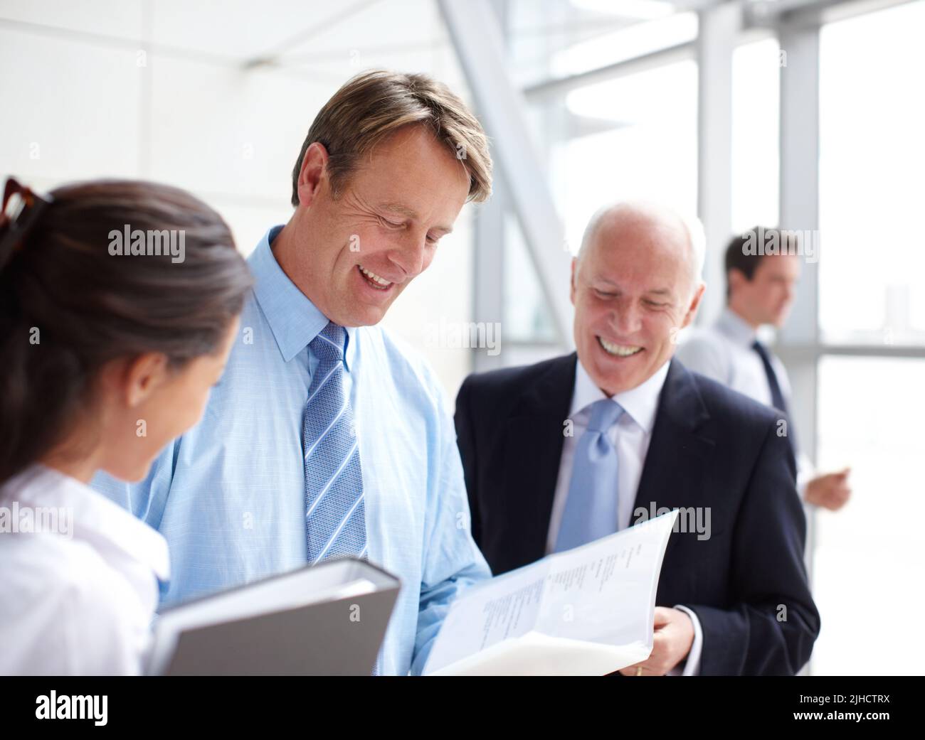 These figures look great. Smiling businesspeople going through ...