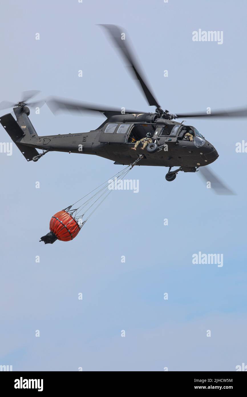 An Oklahoma National Guard UH-60 Black Hawk flies overhead after ...