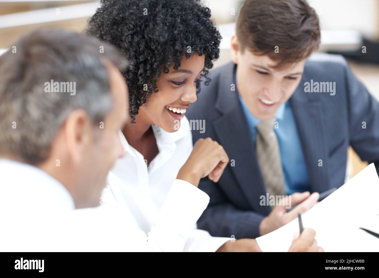 Checking through their agenda. A diverse group of businesspeople ...