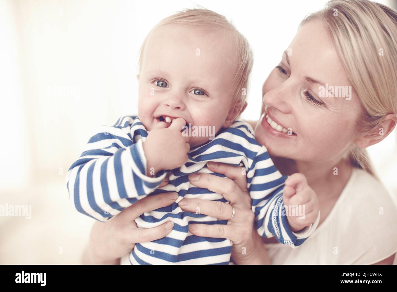 Hes my perfect angel. Cropped view of a cute baby boy being held by his ...