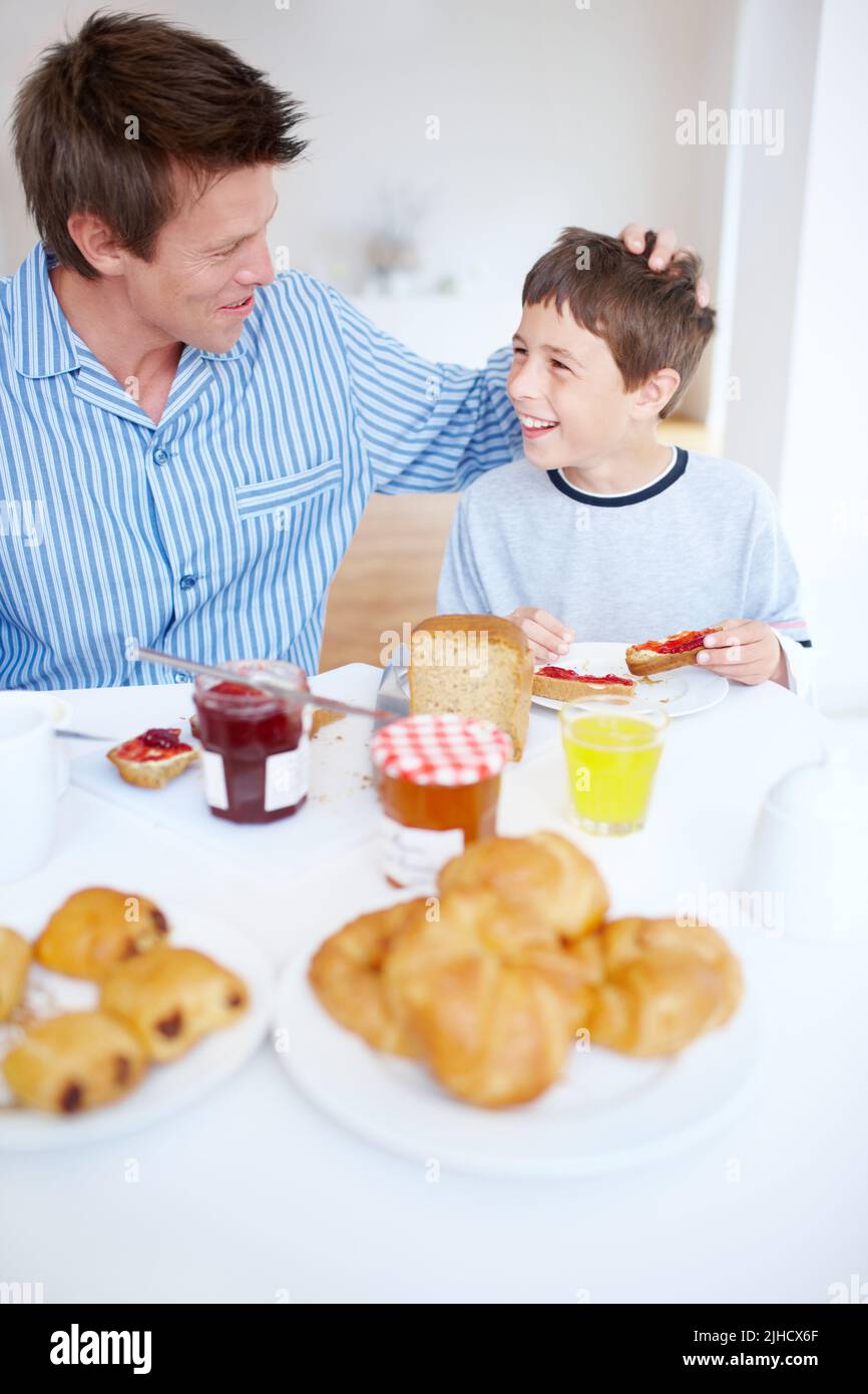 Eat up, my boy, weve got a big day ahead. A proud father ruffling his ...