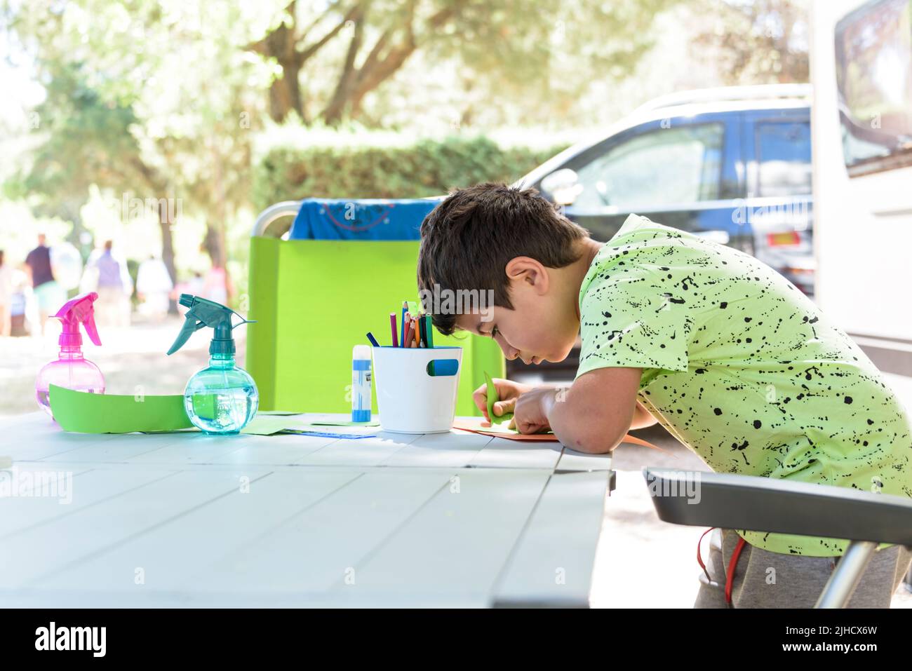 Primary school boy doing manual work while on vacation and preparing to ...